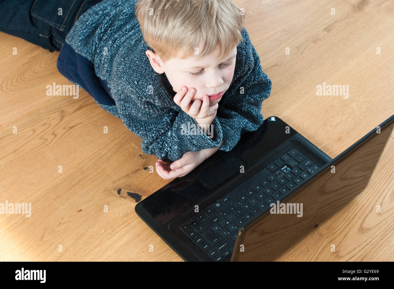 Child using a laptop Stock Photo - Alamy