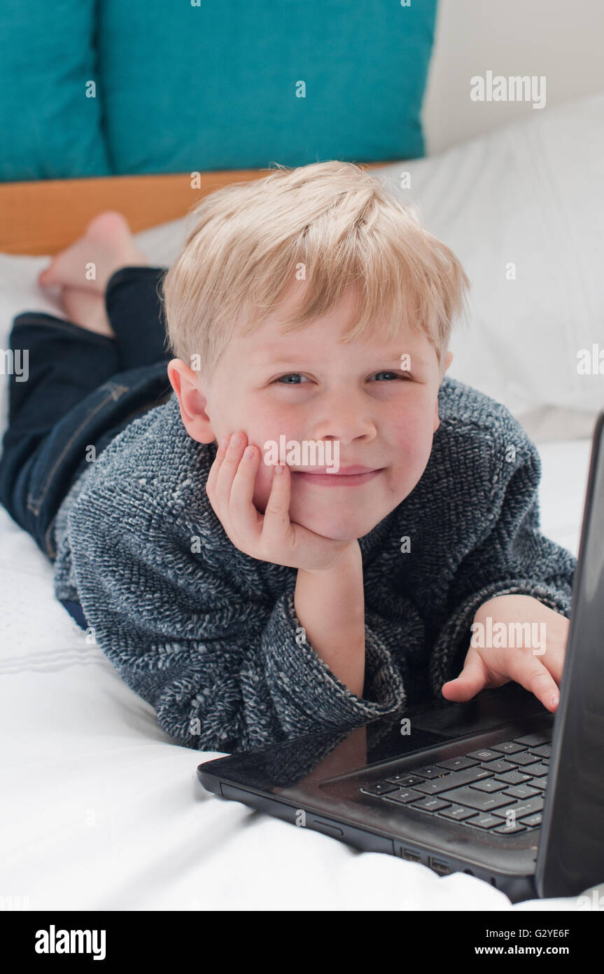 Happy boy using a modern computer Stock Photo - Alamy