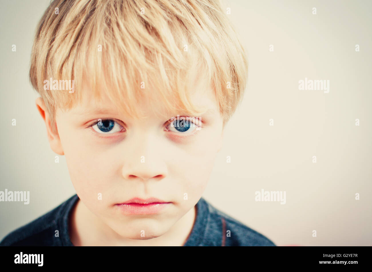 Lonely little boy with a sad expression on his face Stock Photo - Alamy