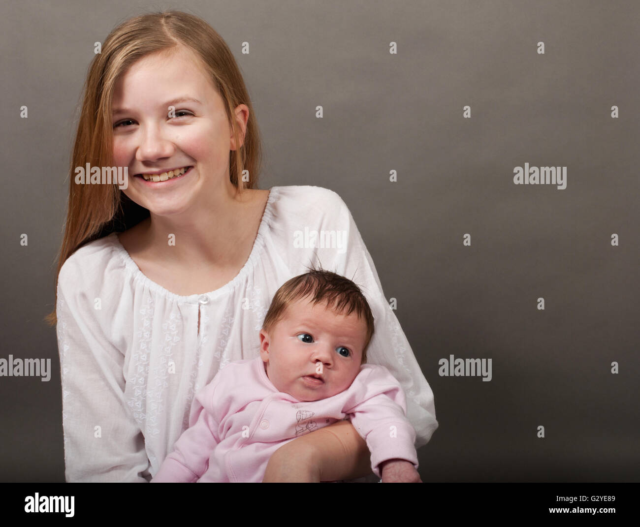 Happy girl holding a new born baby Stock Photo - Alamy