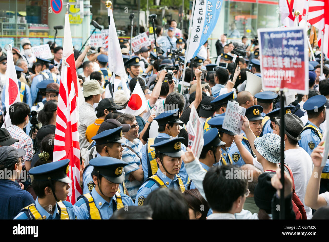 Police guard anti-foreign protesters in Shibuya ward on June 05, 2016 ...
