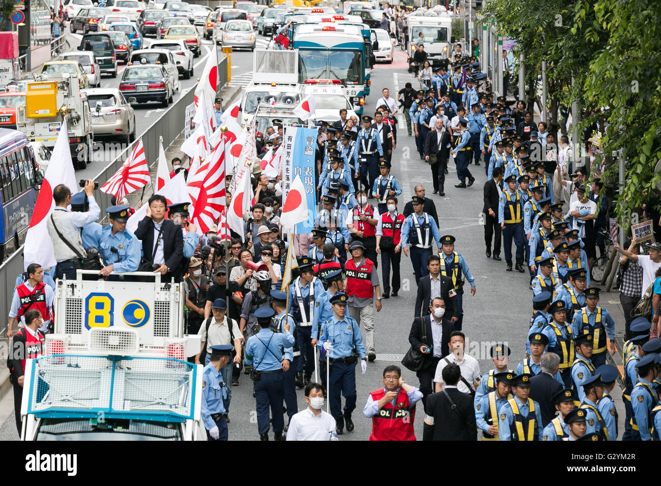 Police guard anti-foreign protesters in Shibuya ward on June 05, 2016 ...