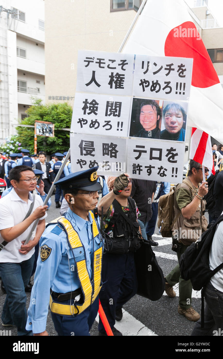 Police guard anti-foreign protesters in Shibuya ward on June 05, 2016 ...