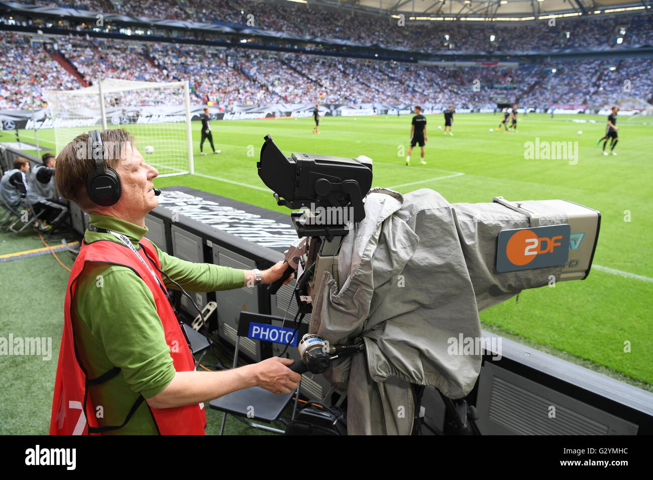 A camera operator films using a television camera of German public ...