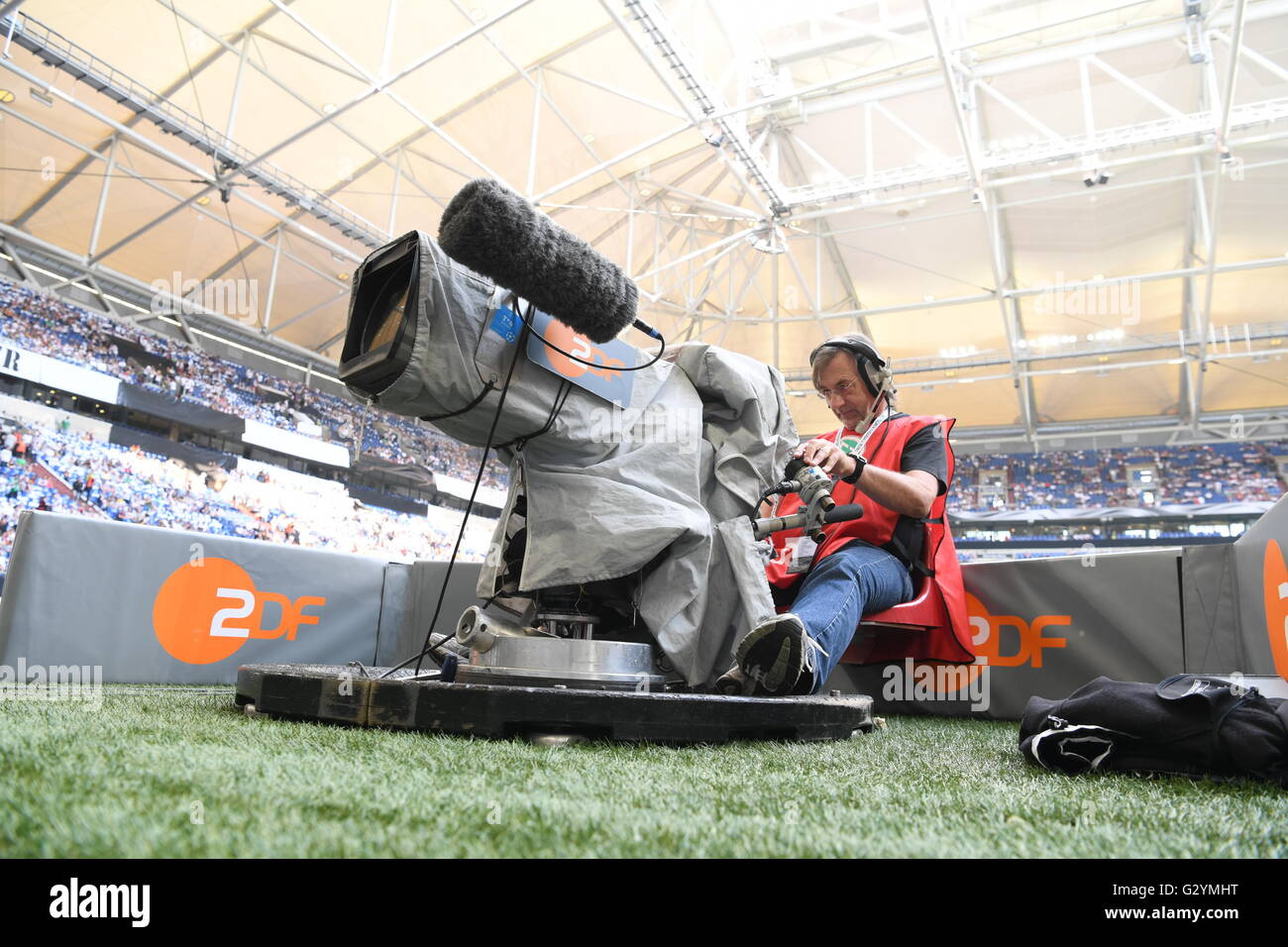 A camera operator films using a television camera of German public ...