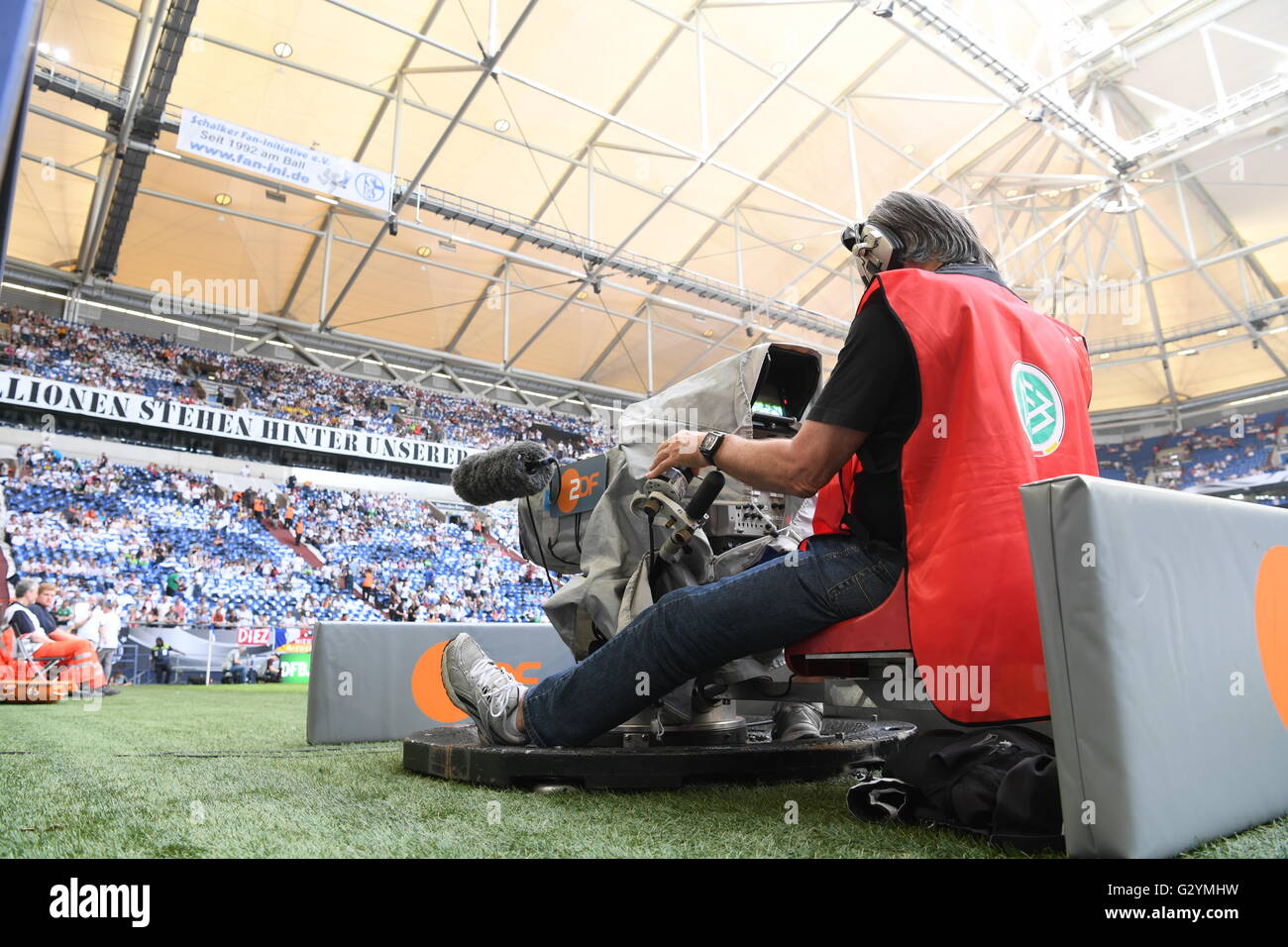 A camera operator films using a television camera of German public ...