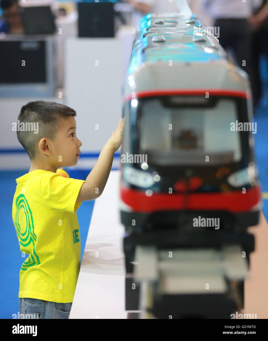 Beijing, China. 5th June, 2016. A boy touches a model of a maglev train ...
