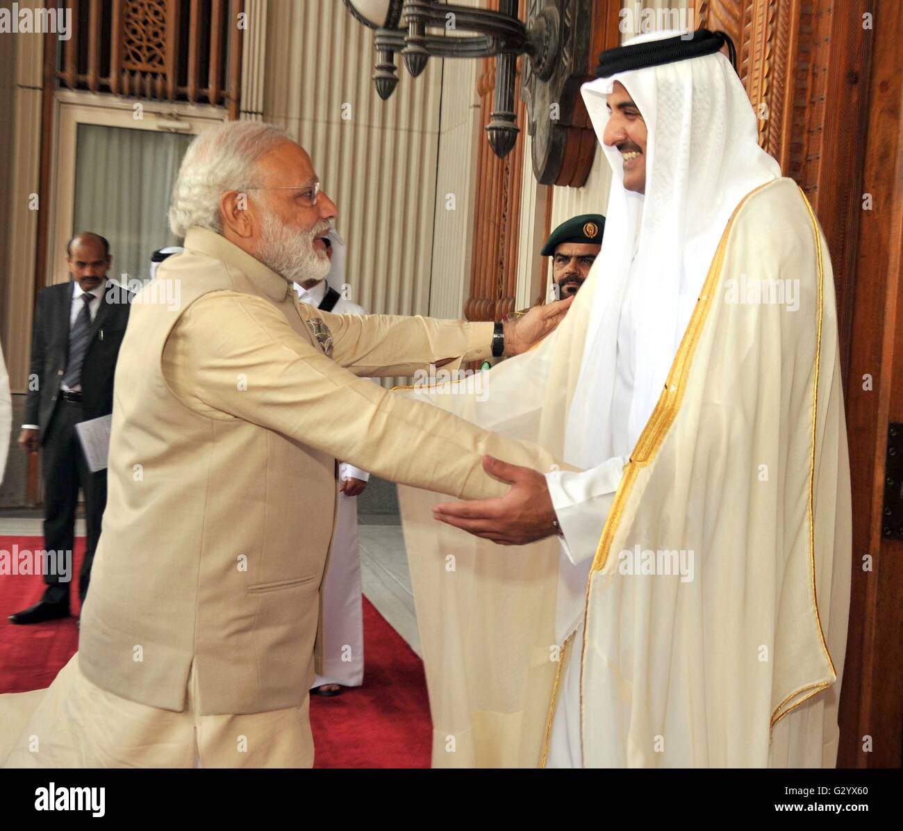 Emir of Qatar Sheikh Tamim Bin Hamad Al Thani, right, greets Indian Prime Minister Narendra Modi ...