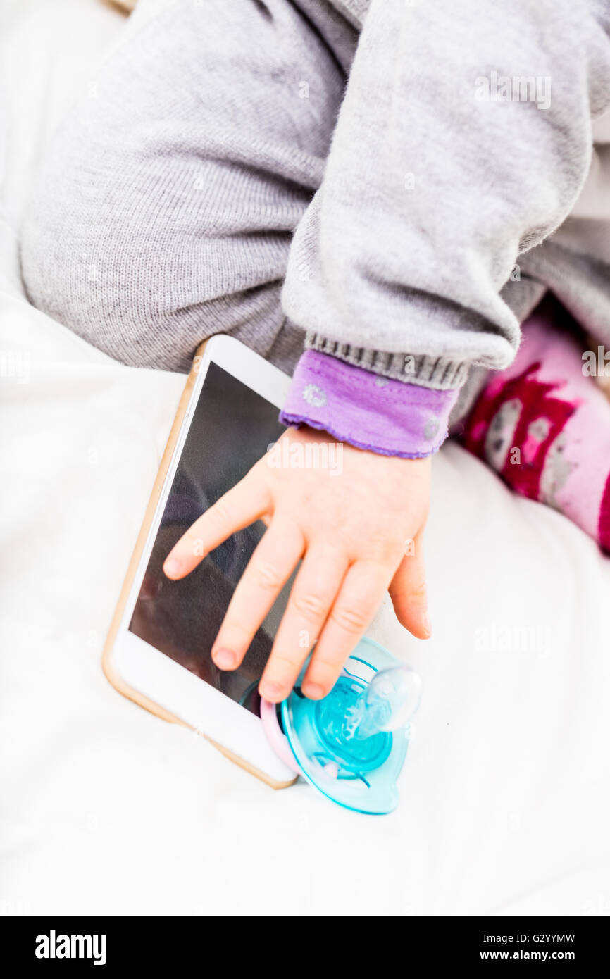 hand of a children picking pacifier and smartphone Stock Photo - Alamy