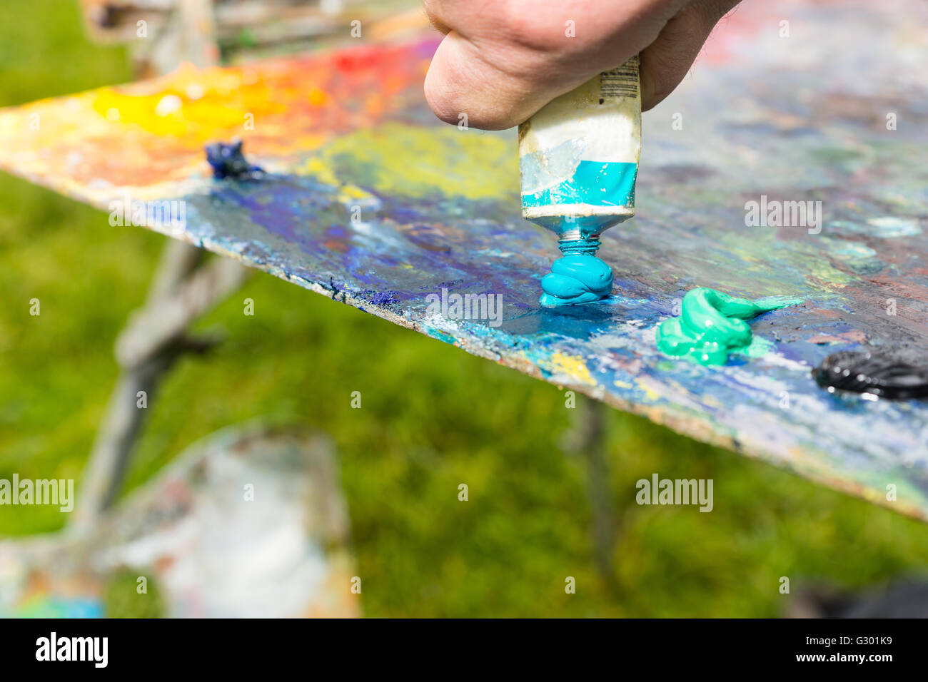 Artist Squeeze Tube Of Blue Paint On The Palette Stock Photo - Alamy