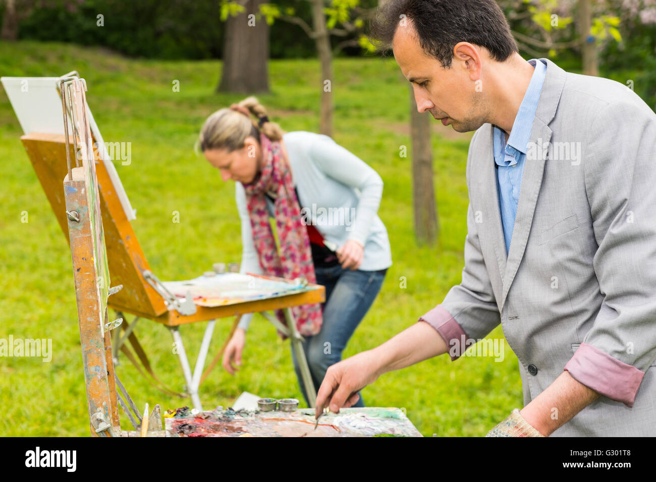 Couple artists working on painting hi-res stock photography and images ...