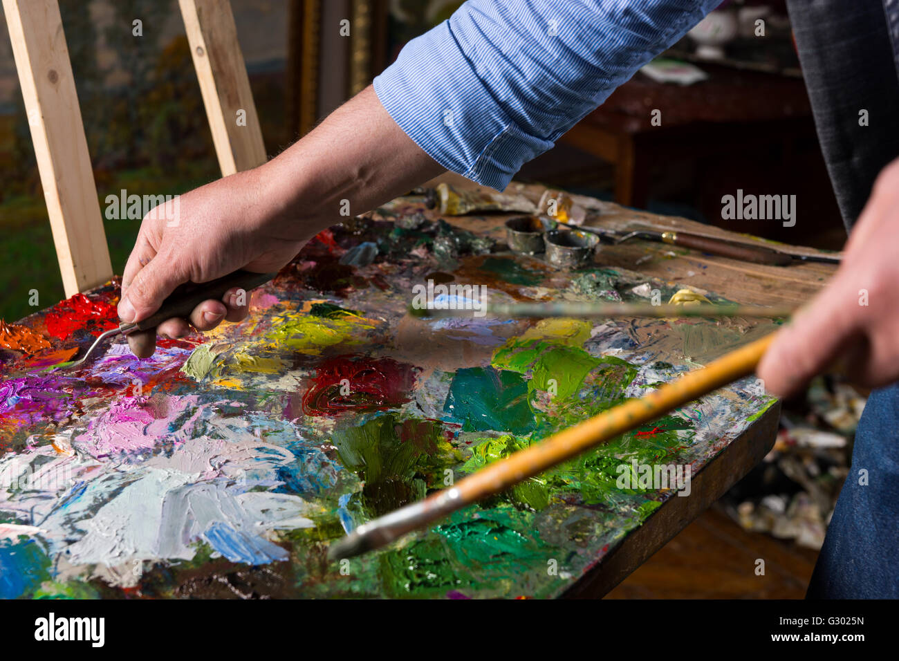 Artists hand holding palette brushes High Resolution Stock Photography ...
