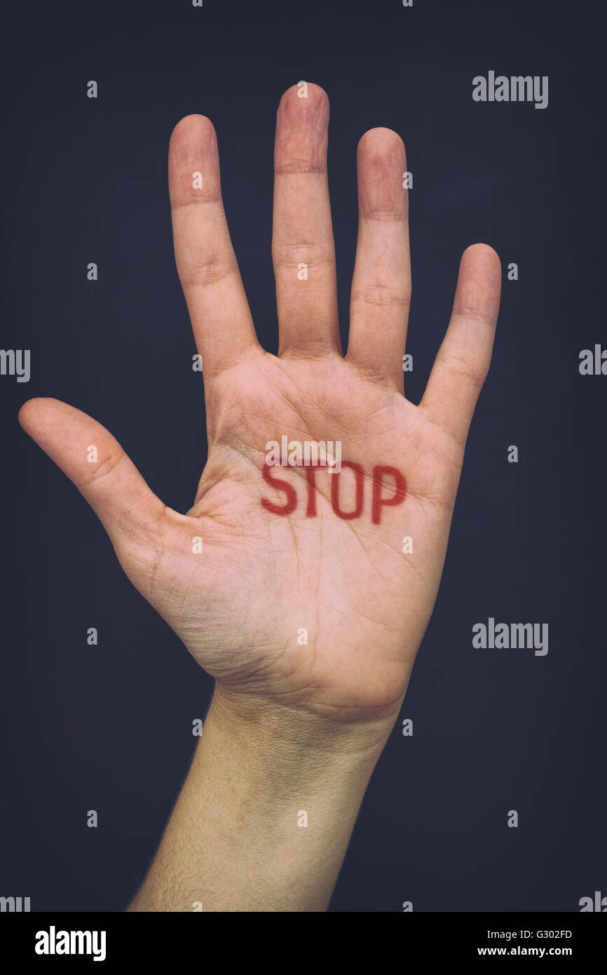 Hand with writting Stop. Close up Stock Photo - Alamy