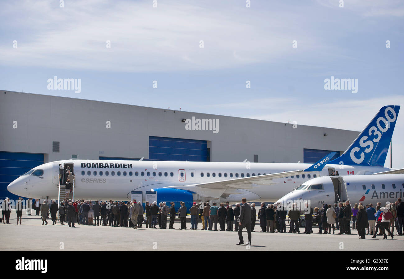 Bombardier shareholders wait in line to take a tour of a Bombardier C ...