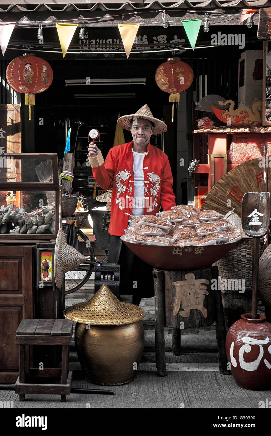 China Town street market vendor in traditional Chinese red costume ...