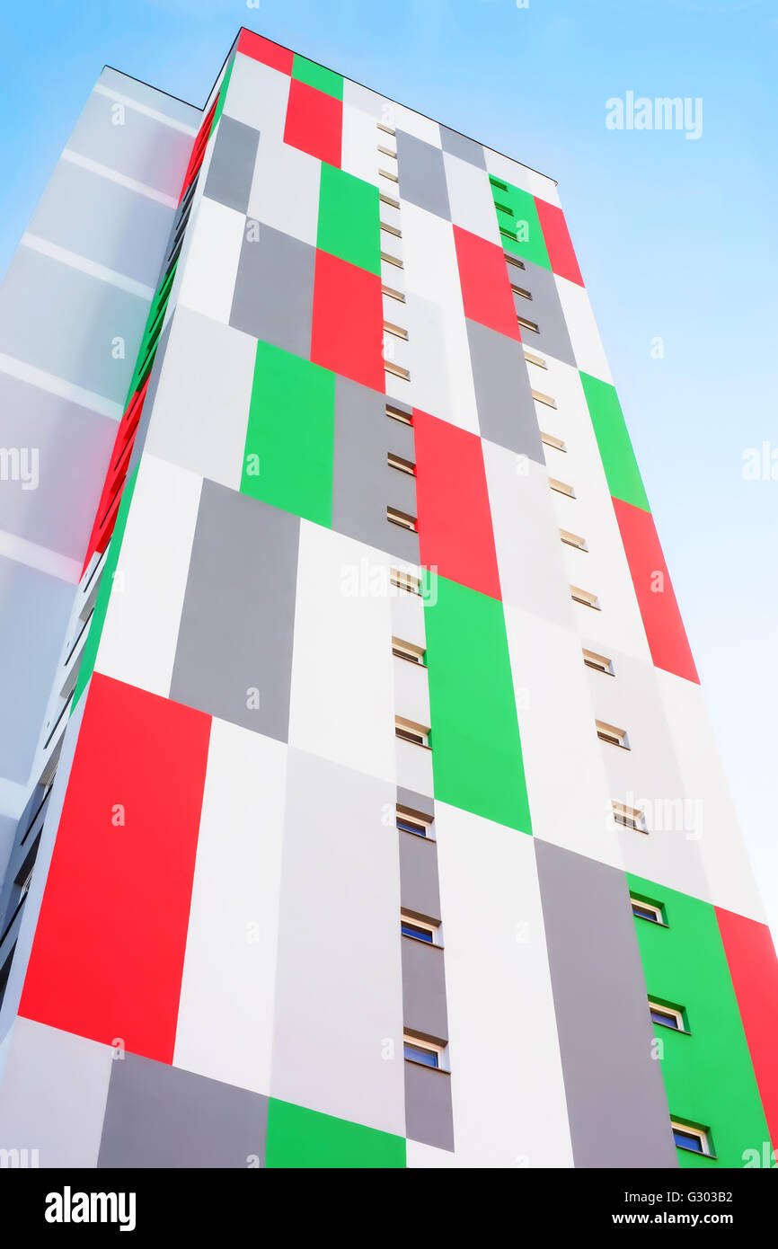 High-rise colored modern building wall with squared pattern in sunny ...