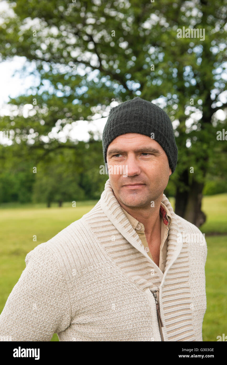 Man wearing a beanie standing in a park Stock Photo - Alamy
