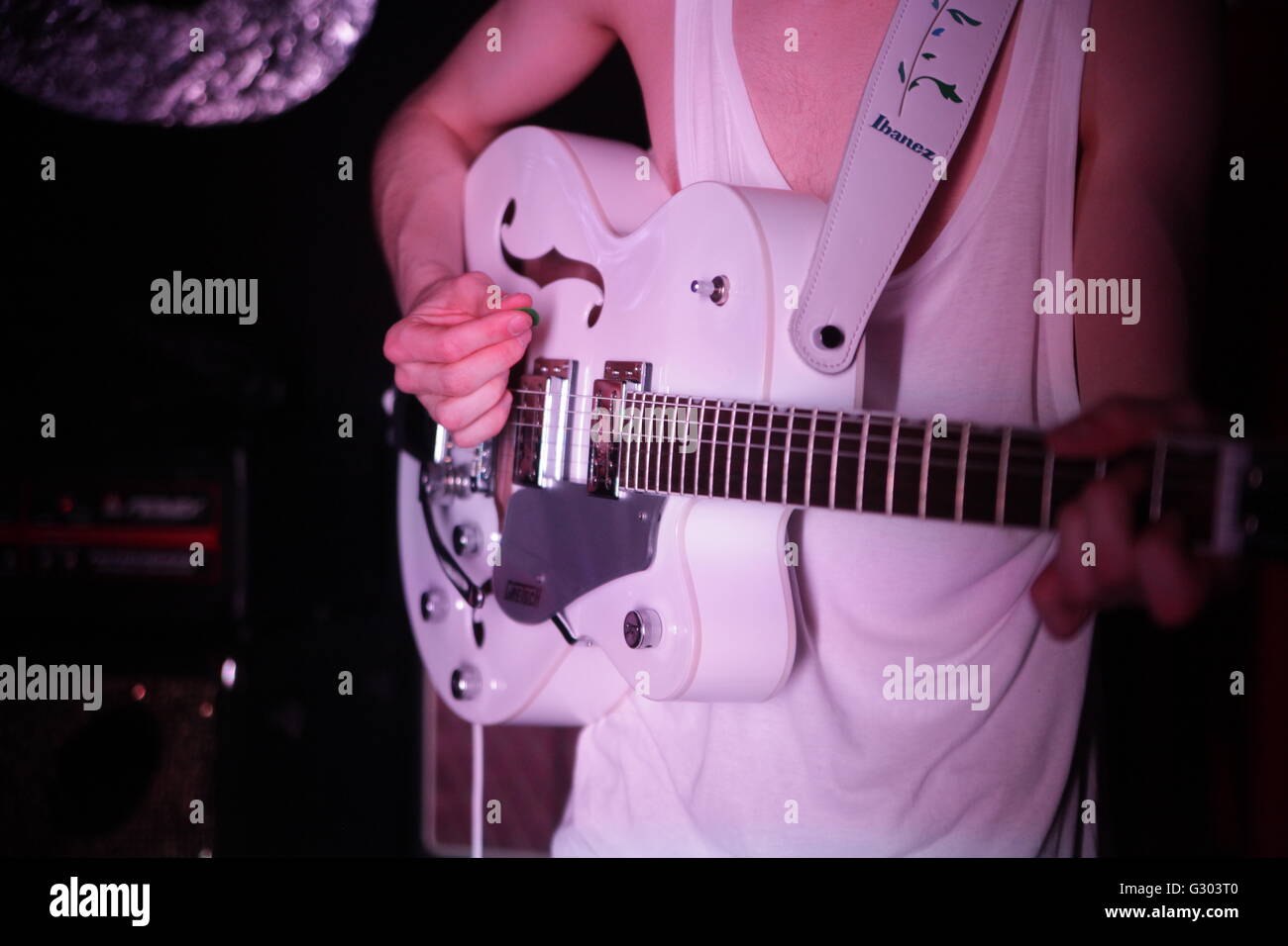 Guitar player performing at a concert Stock Photo - Alamy