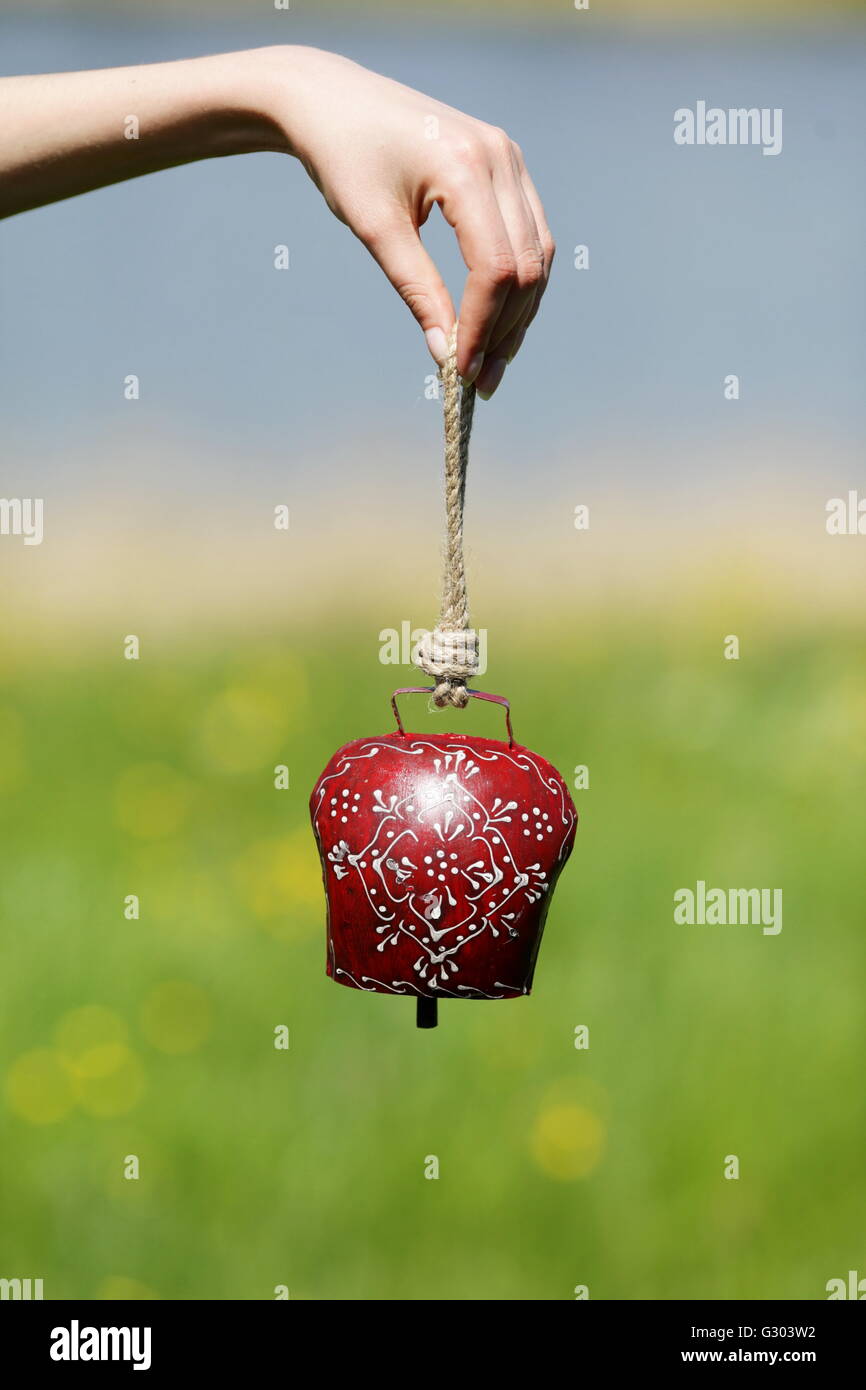 Woman's hand holding an Allgaeu cowbell Stock Photo - Alamy