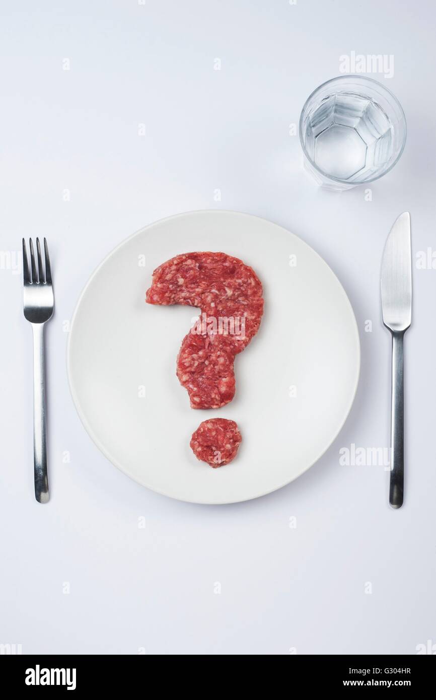 Red meat on a white plate in the shape of question mark Stock Photo - Alamy