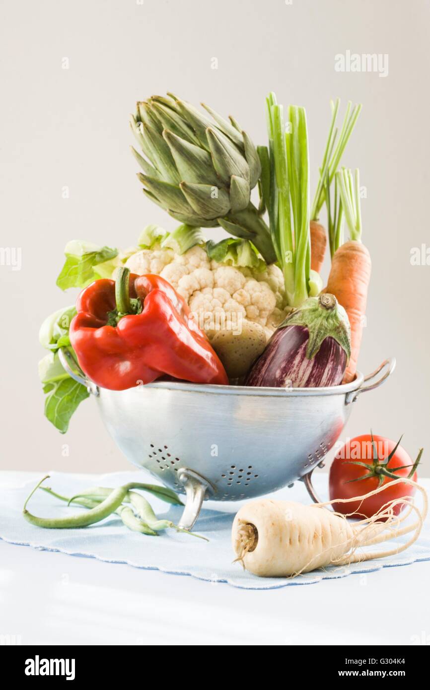 Selection of fresh vegetables in a colander Stock Photo - Alamy