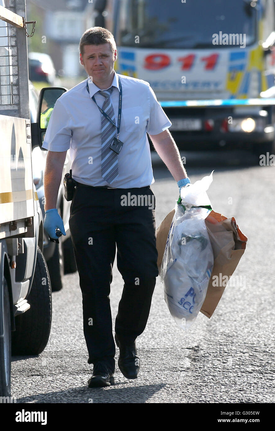 A police officer carries evidence bags scene hi-res stock photography ...