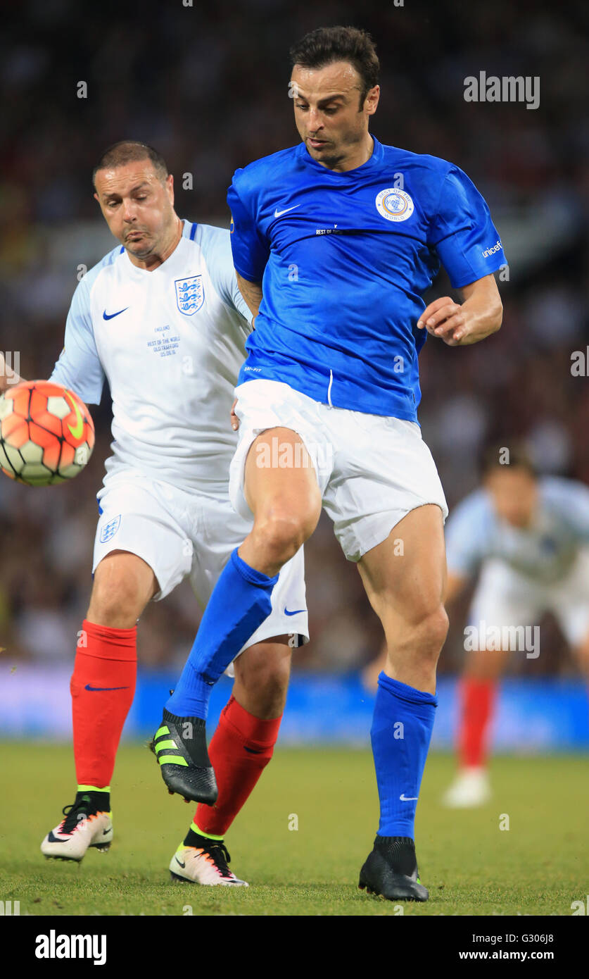 Rest of the World's Dimitar Berbatov (right) and England's Paddy McGuinness battle for the ball ...