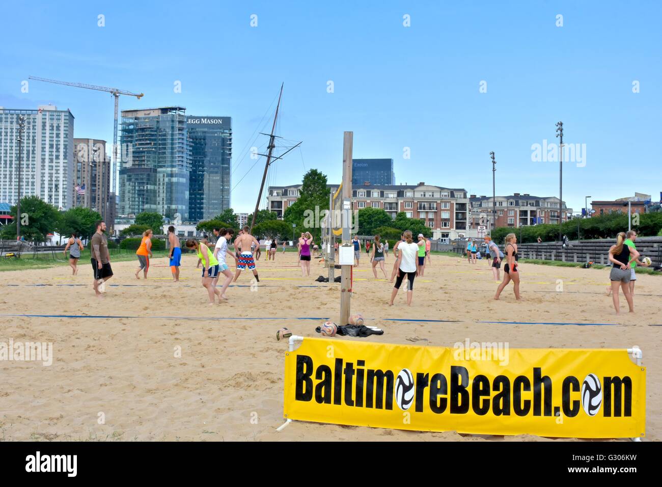 People enjoying a day at the Baltimore Inner harbor while playing beach ...