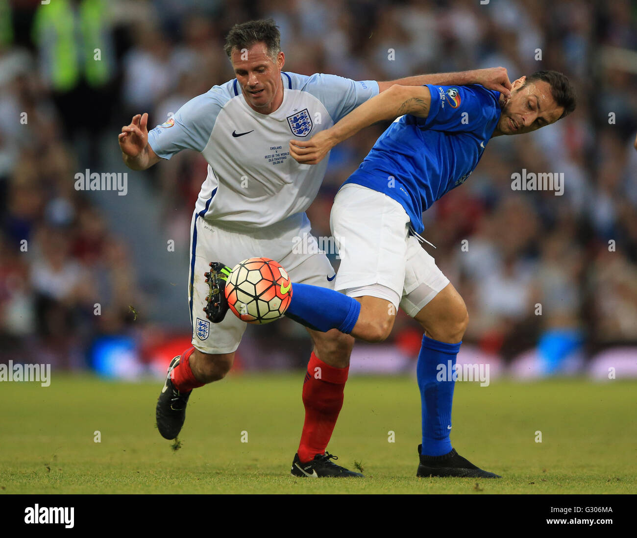 England's Jamie Carragher (left) and Rest of the World's Dimitar Berbatov battle for the ball ...