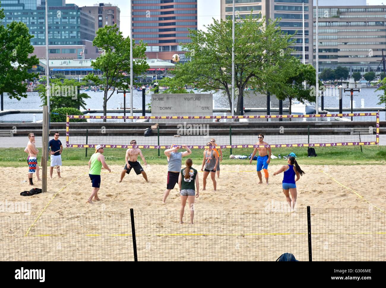 People enjoying a day at the Baltimore Inner harbor while playing beach ...