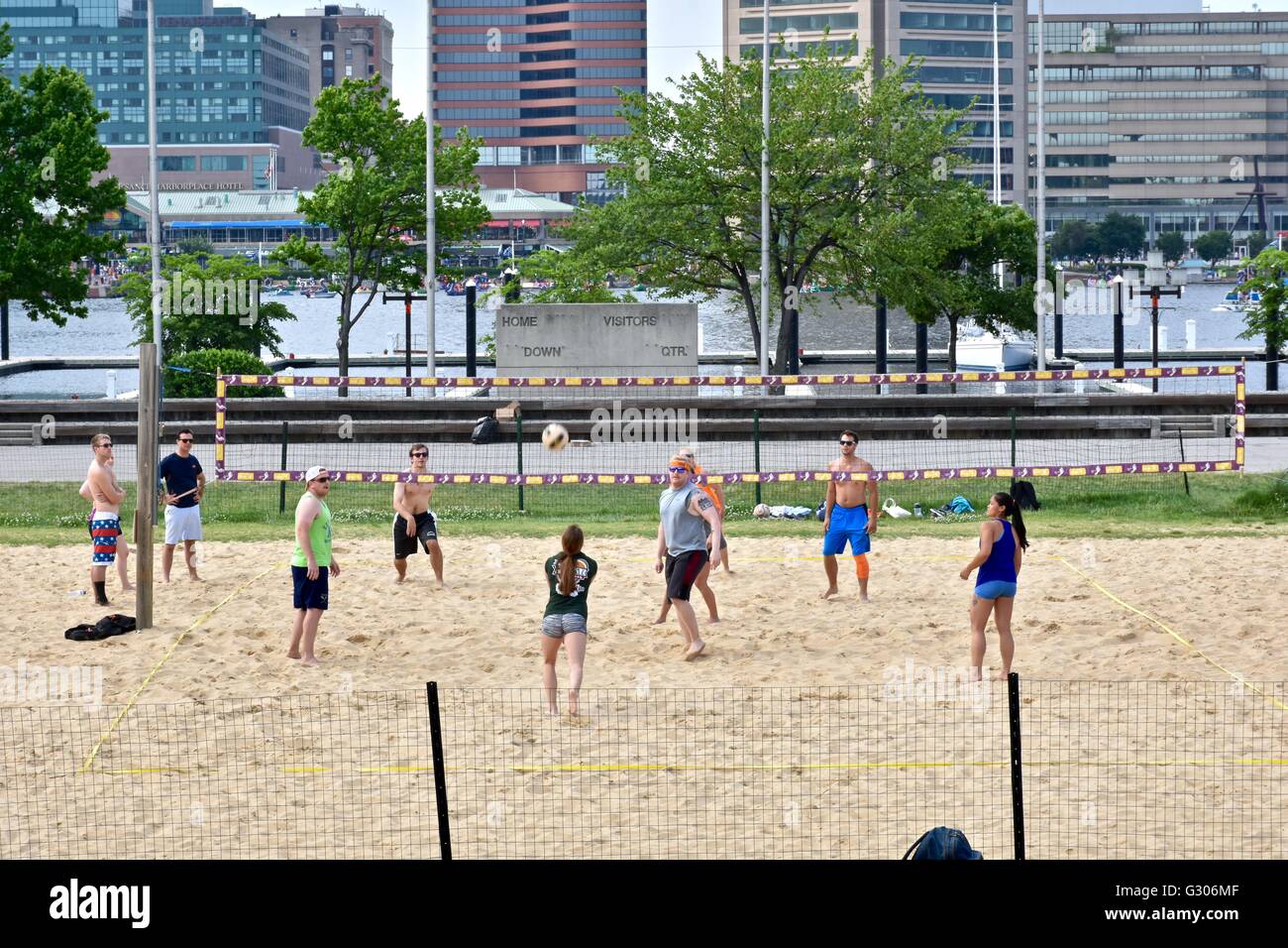 People enjoying a day at the Baltimore Inner harbor while playing beach ...
