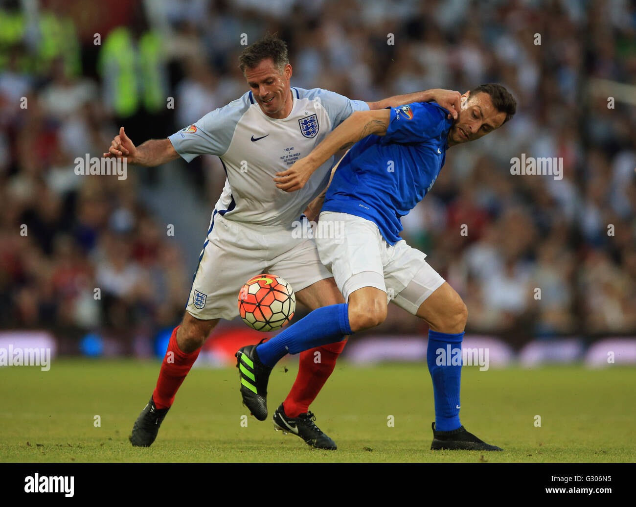 England's Jamie Carragher (left) and Rest of the World's Dimitar Berbatov battle for the ball ...