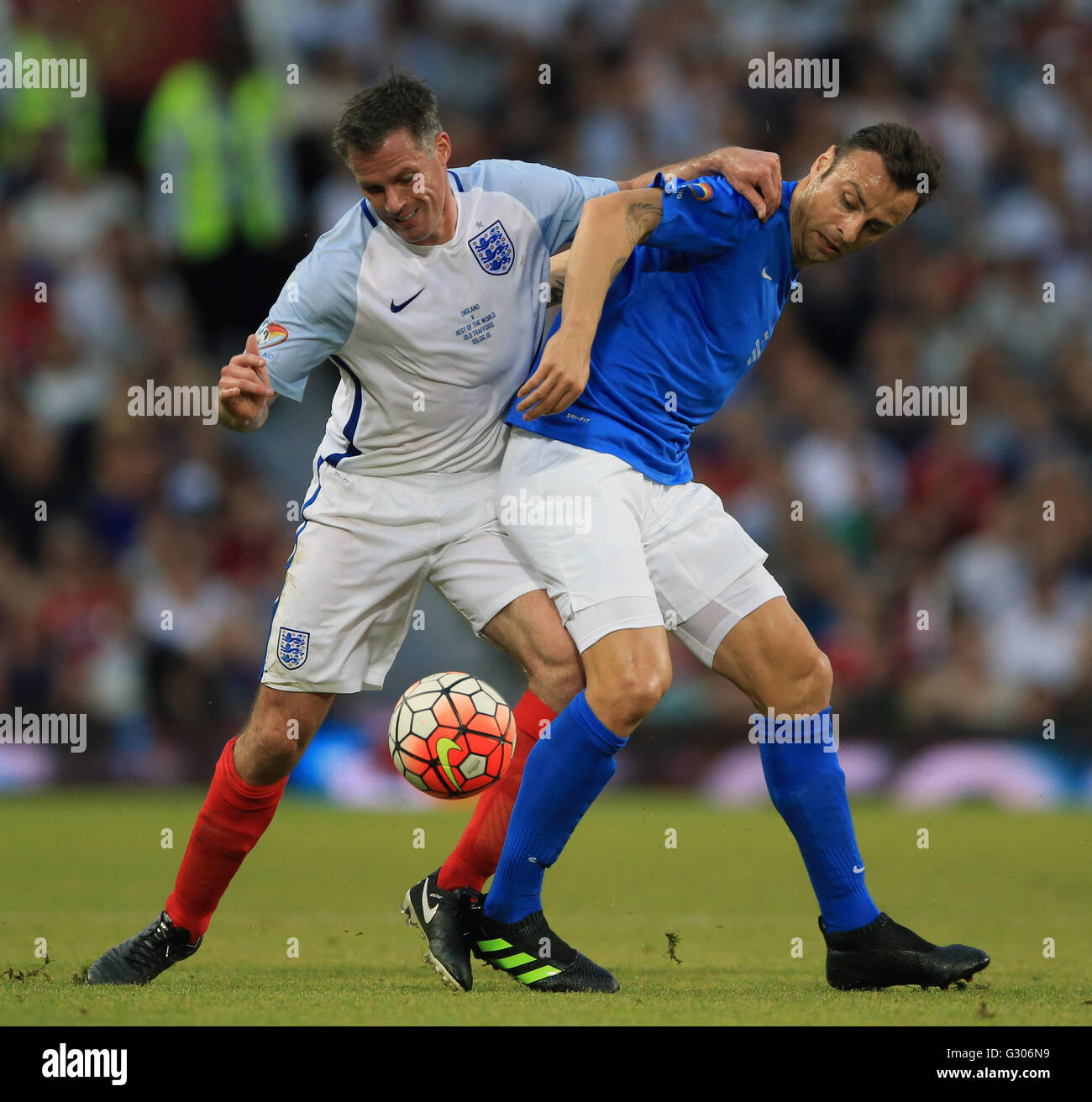 England's Jamie Carragher (left) and Rest of the World's Dimitar Berbatov battle for the ball ...