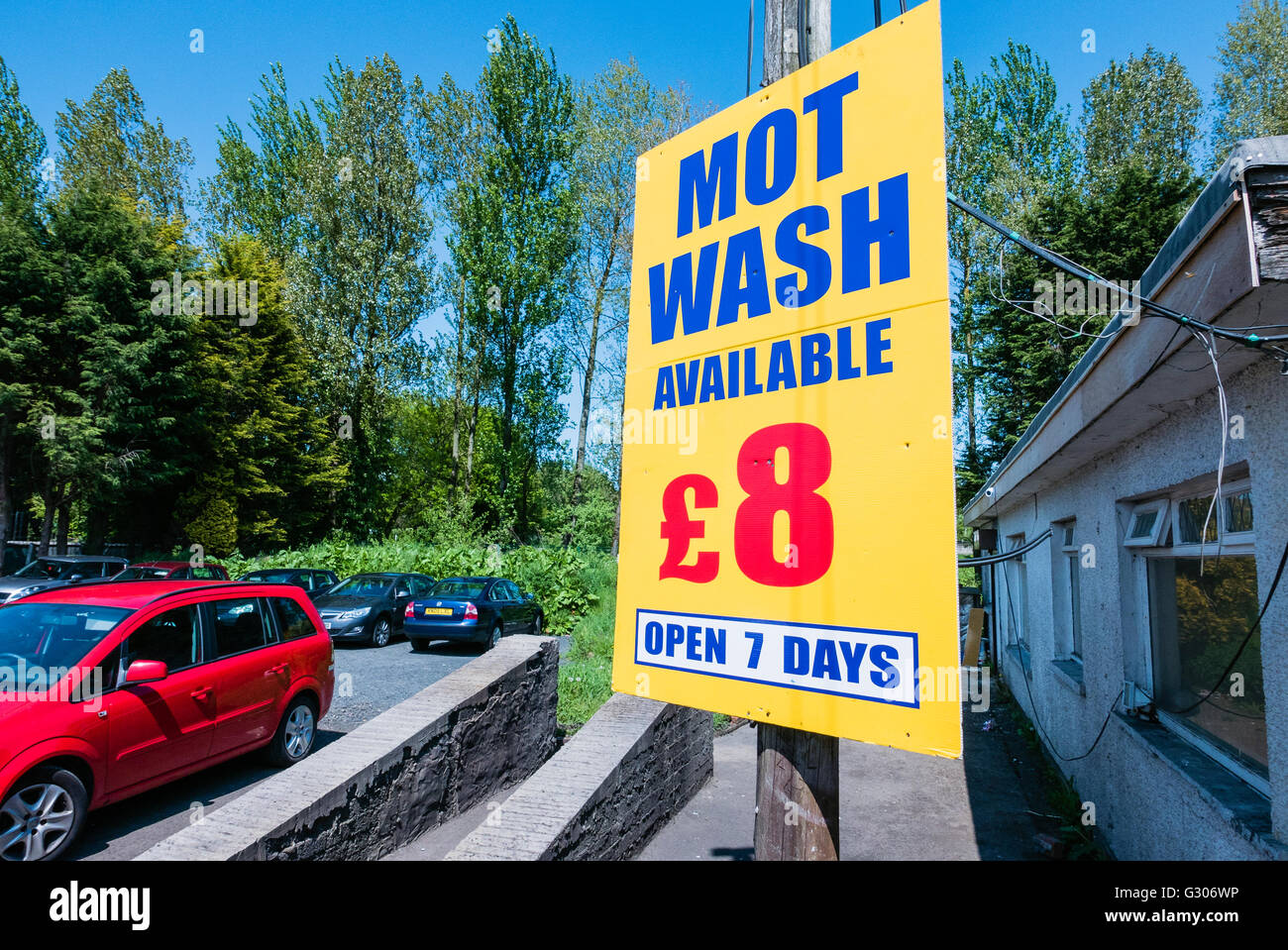 Sign advertising an MOT under vehicle wash Stock Photo - Alamy