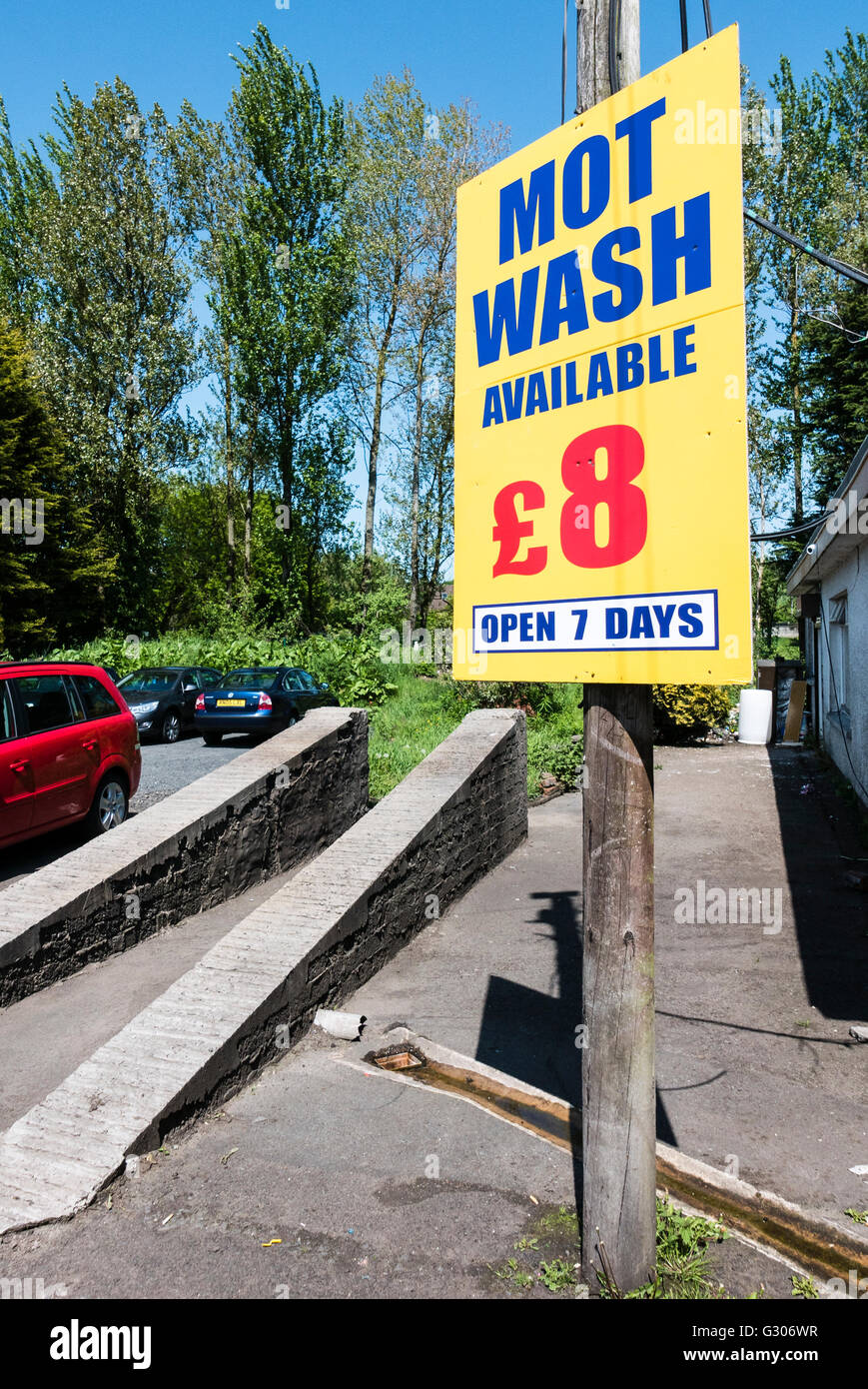 Sign advertising an MOT under vehicle wash Stock Photo - Alamy