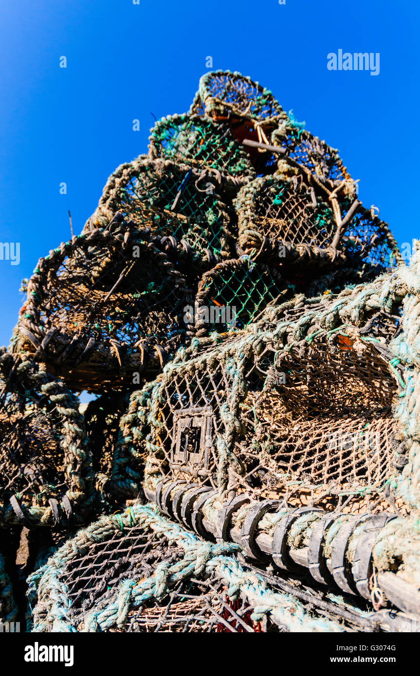 Lobster cages traps stacked up at a fishing harbour Stock Photo - Alamy