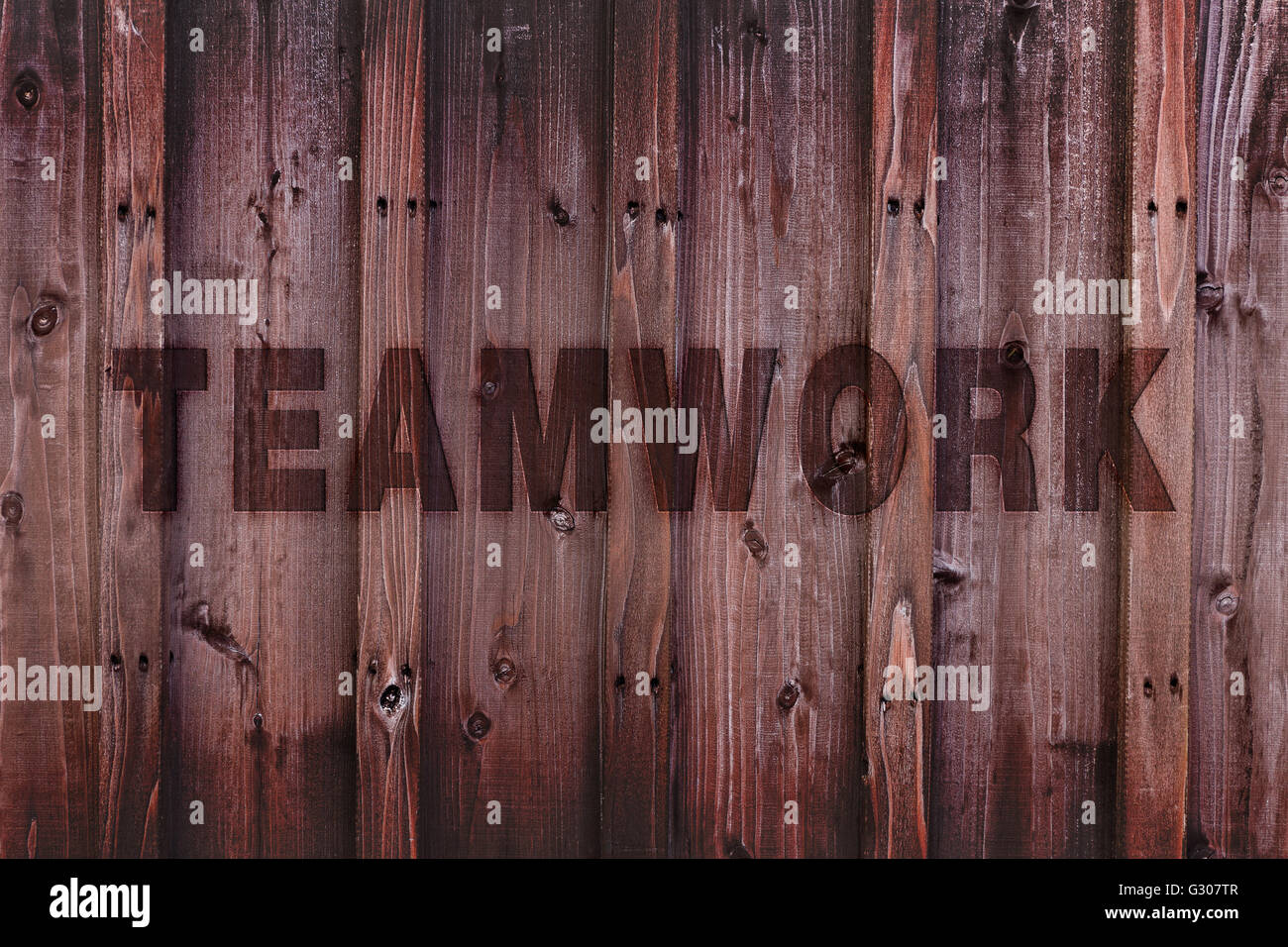 Teamwork word engraved on wood expressing teamwork concept Stock Photo - Alamy