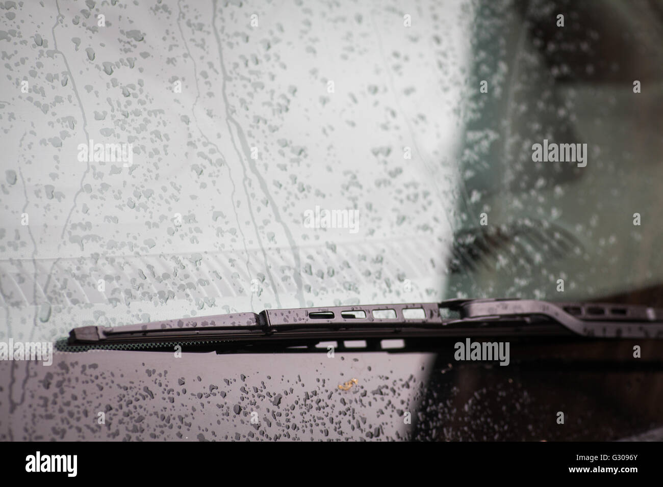 Color image of the wipers of a car, with rain drops on the windshield ...