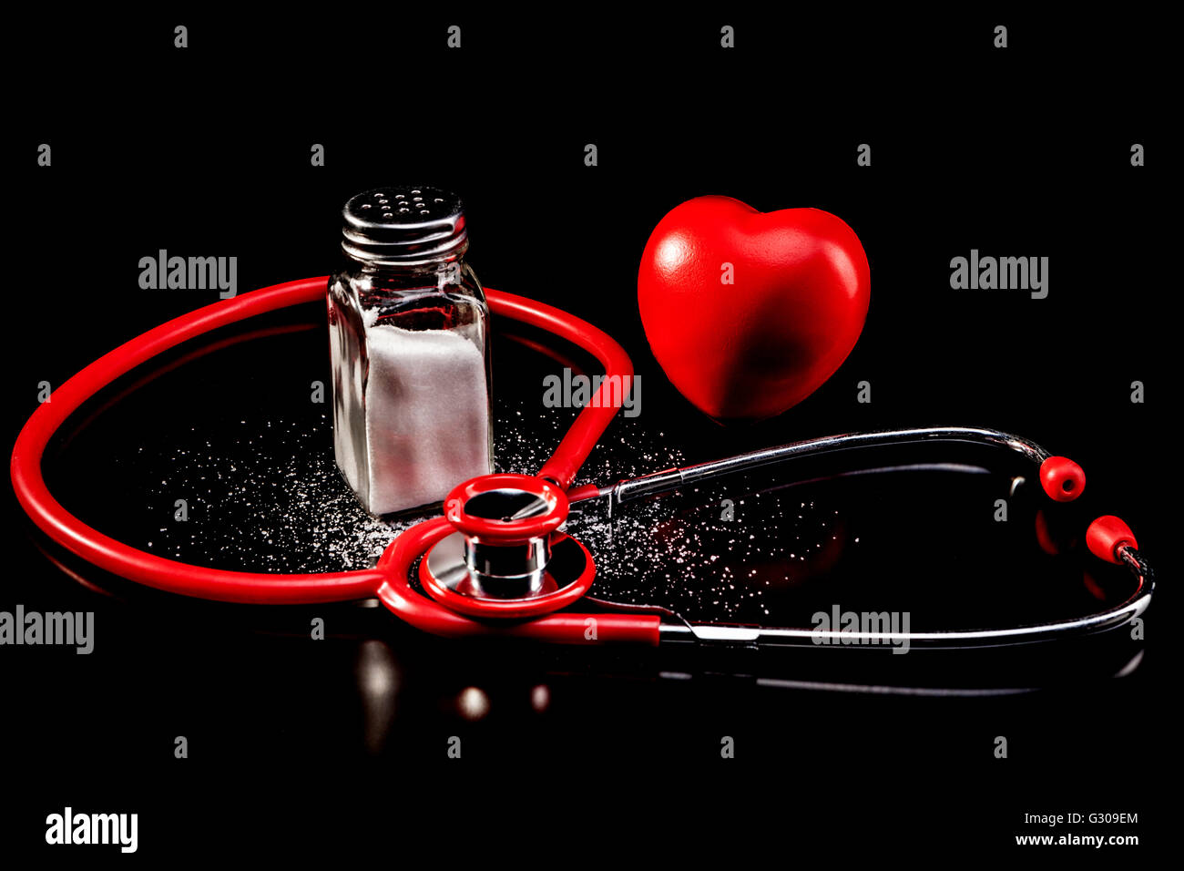 Medical instrument and salt isolated on black background with ...