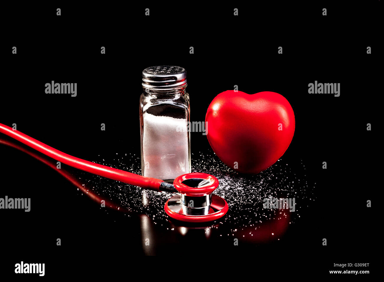 Medical instrument and salt isolated on black background with ...
