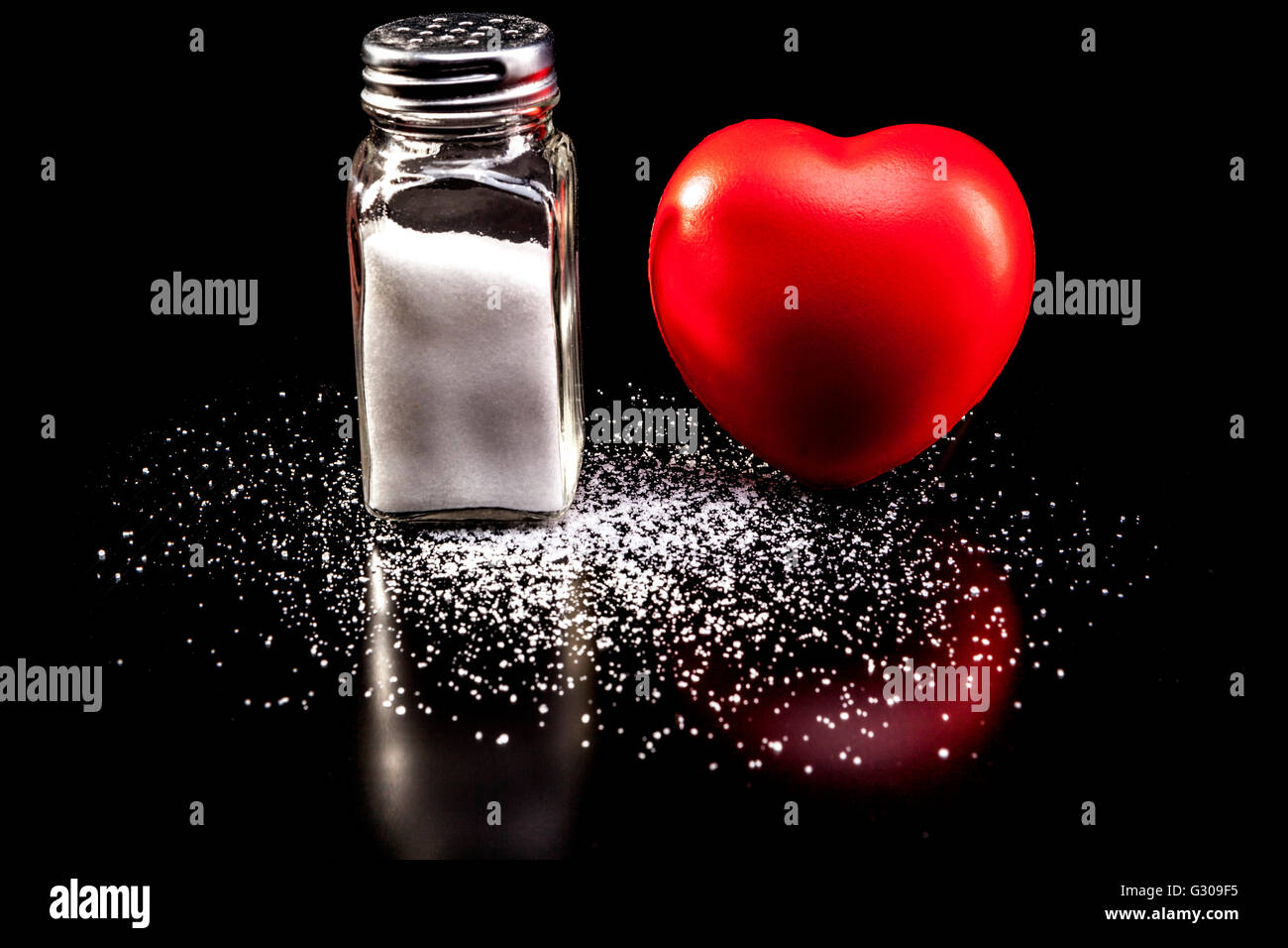 Salt and heart isolated on black background with reflection Stock Photo ...