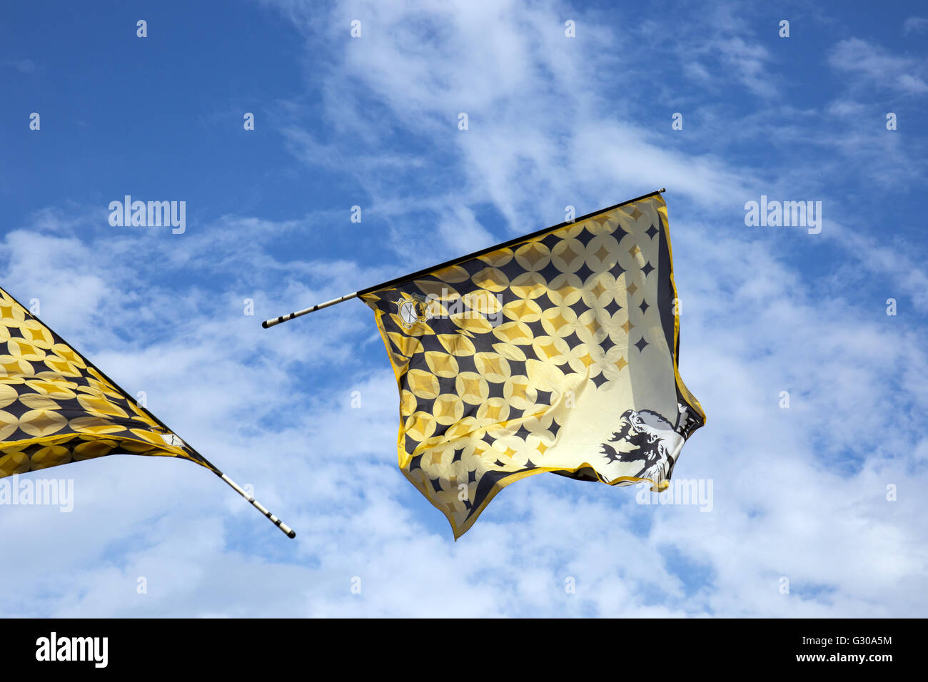 Traditional italian festival with flag throwers.Flags on the blue sky ...