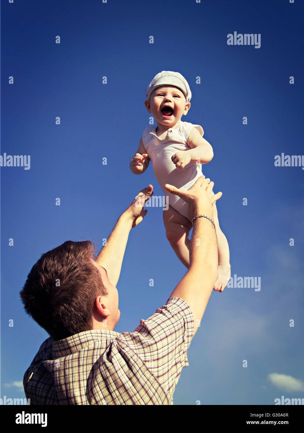Father tossing baby in the air Stock Photo - Alamy