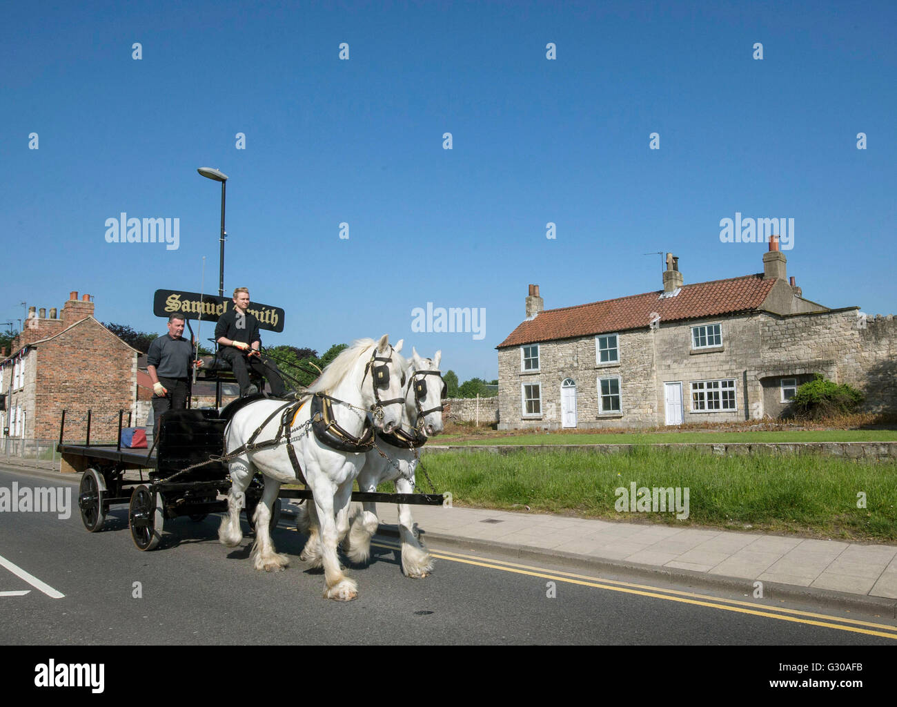 Kegs of beer are delivered to local pubs by a horse drawn cart form the ...