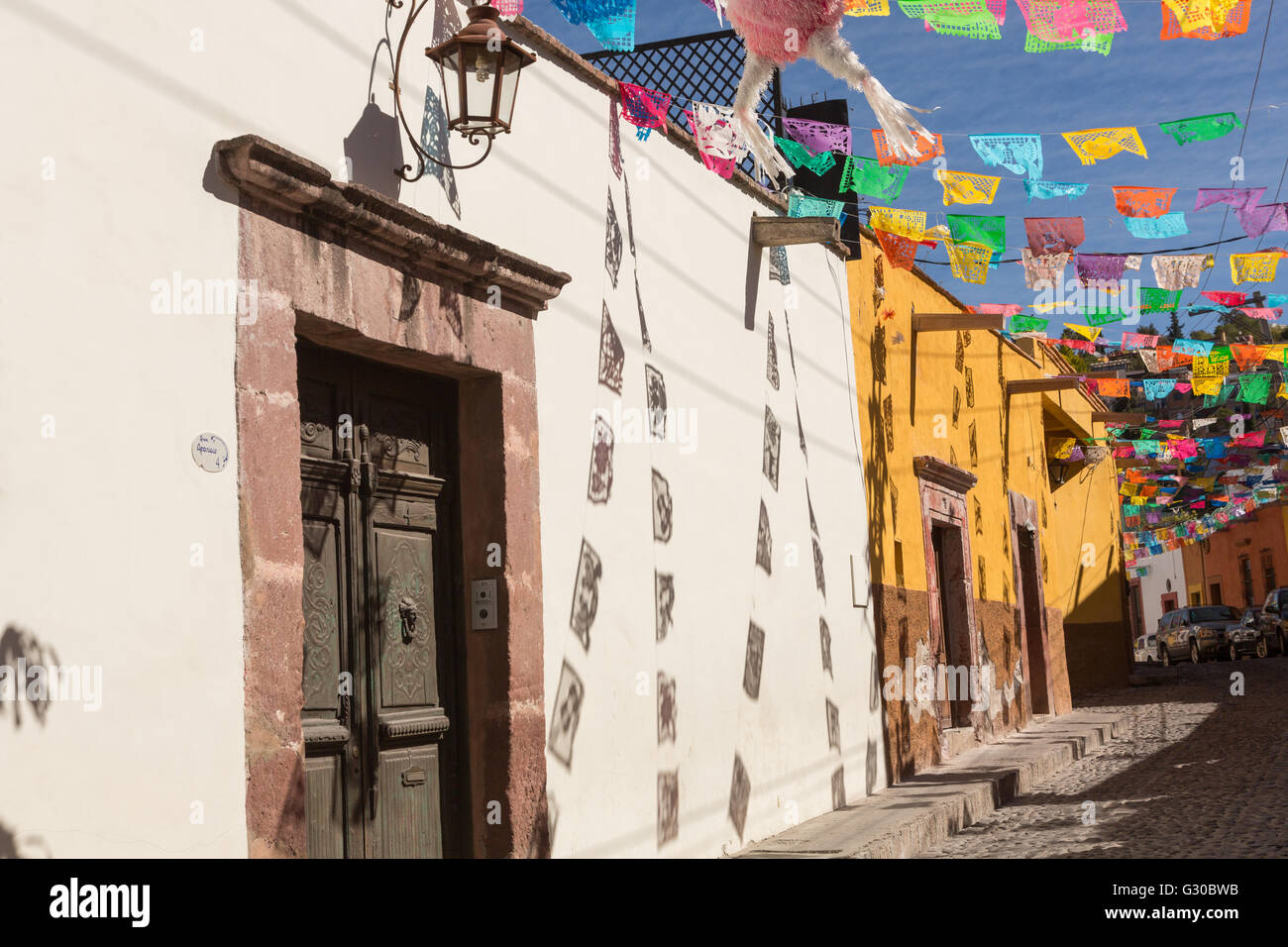 Festive papel picado banners decorate Calle Aparicio in the historic ...