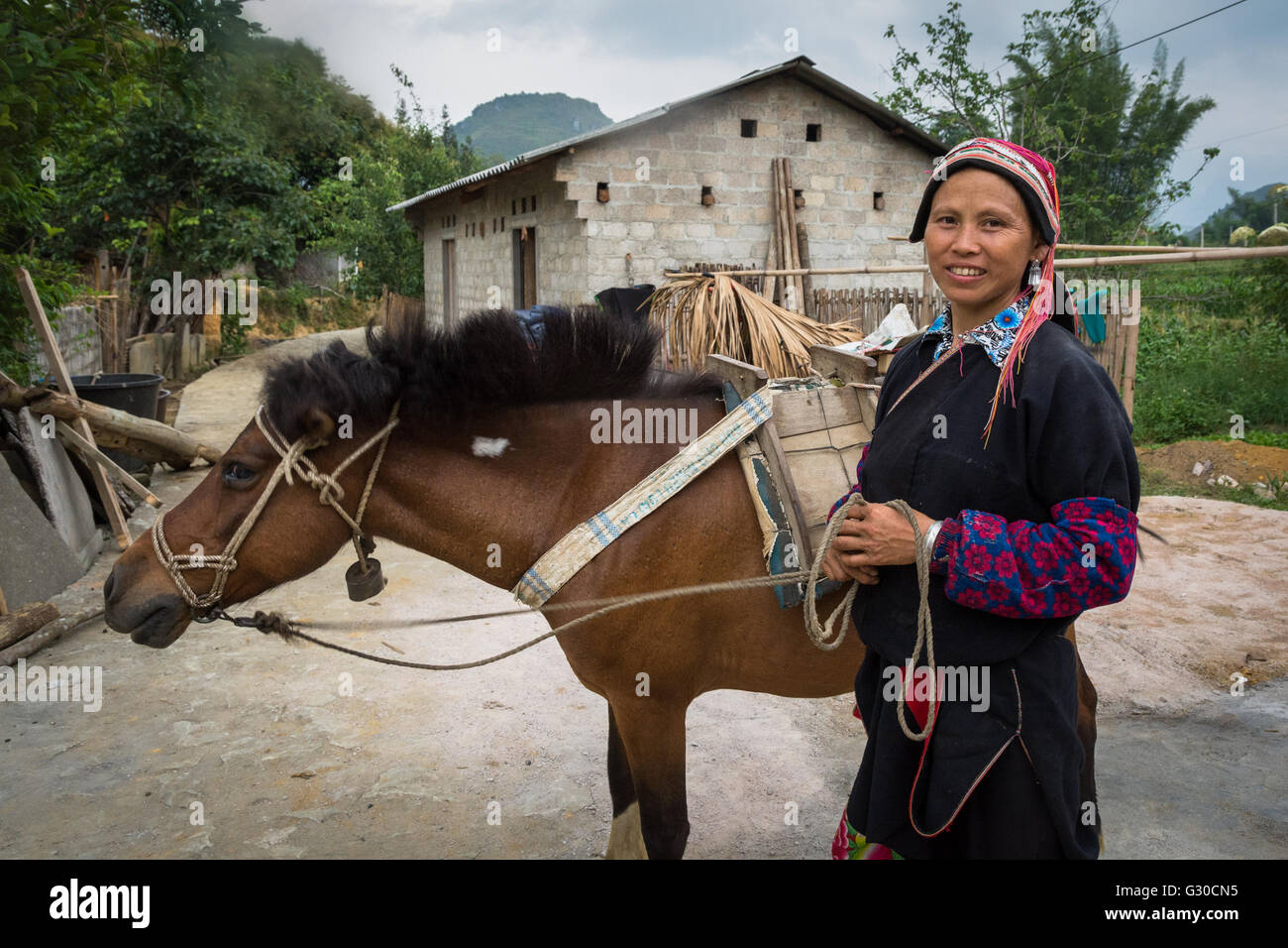 Red Dao woman and her horse on the farm of the Ly Dai Duyen Guest House ...
