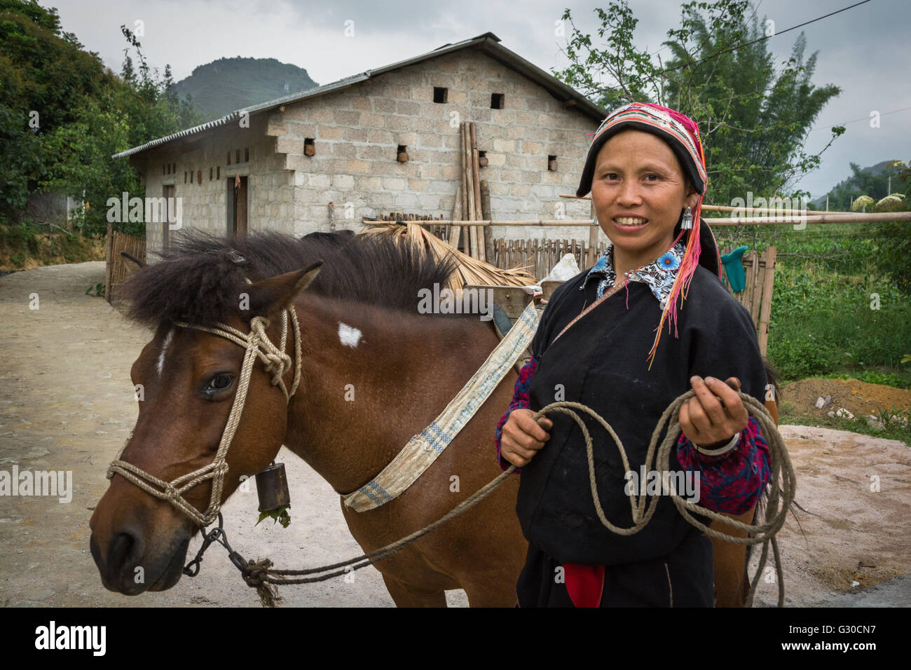 Red Dao woman and her horse on the farm of the Ly Dai Duyen Guest House ...