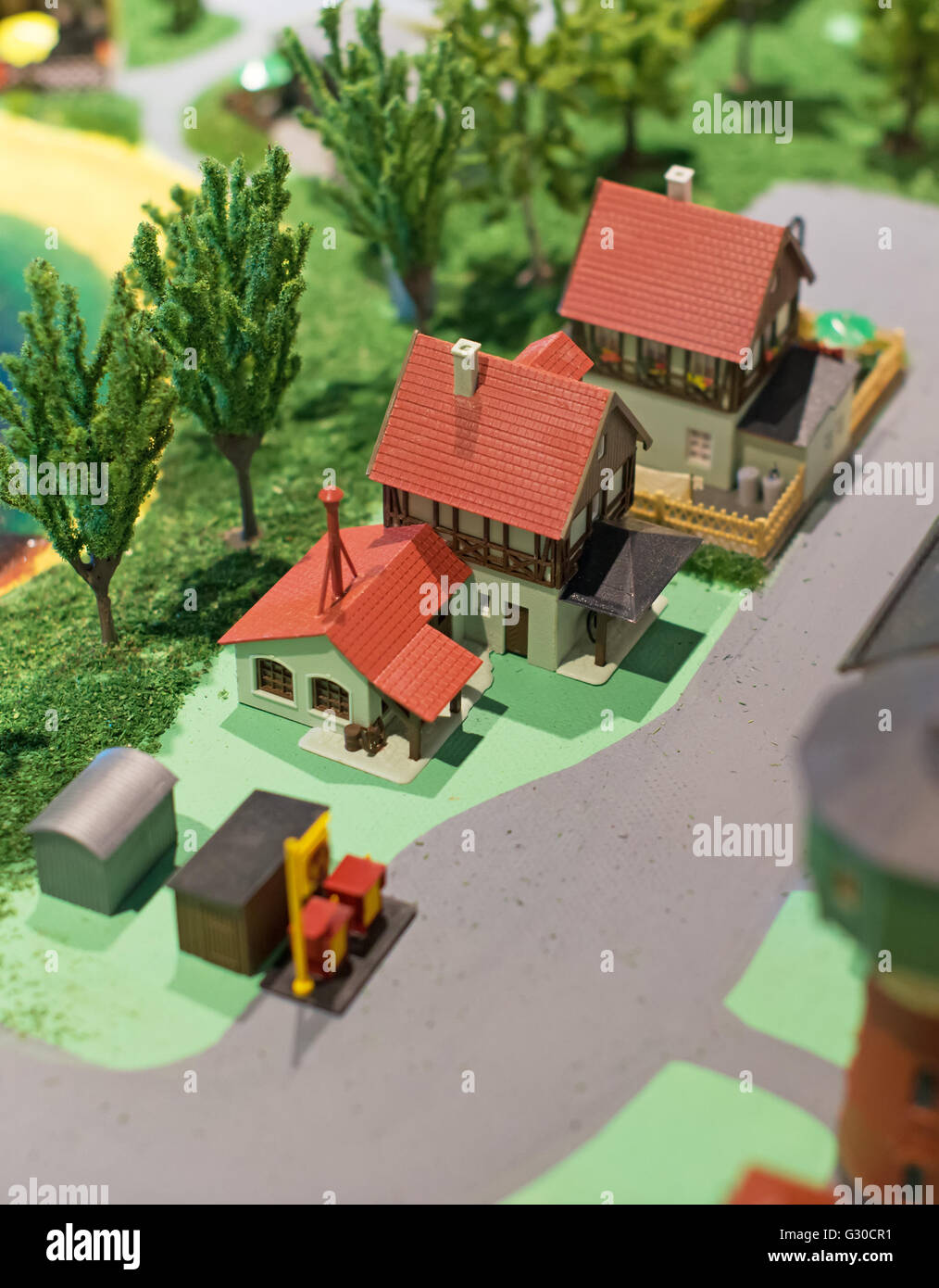 City in miniature. Three plastic houses Stock Photo - Alamy