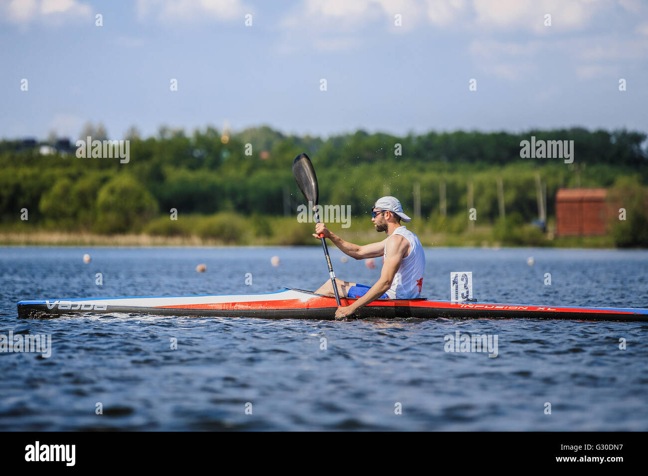 man athlete rower on rowing kayak on lake during Ural championship in ...