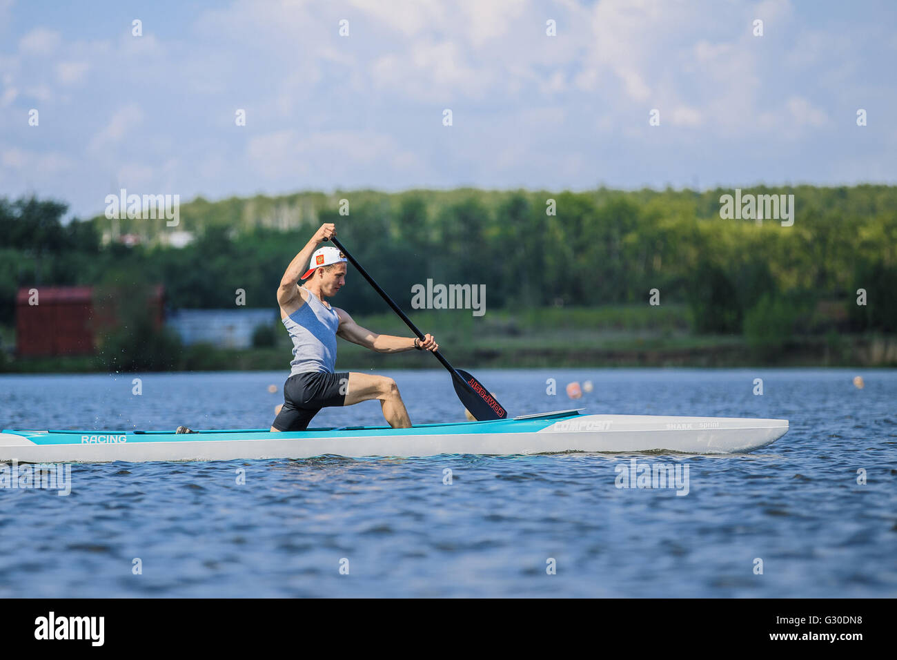 muscular man athlete in a canoe rowing during Ural championship in ...